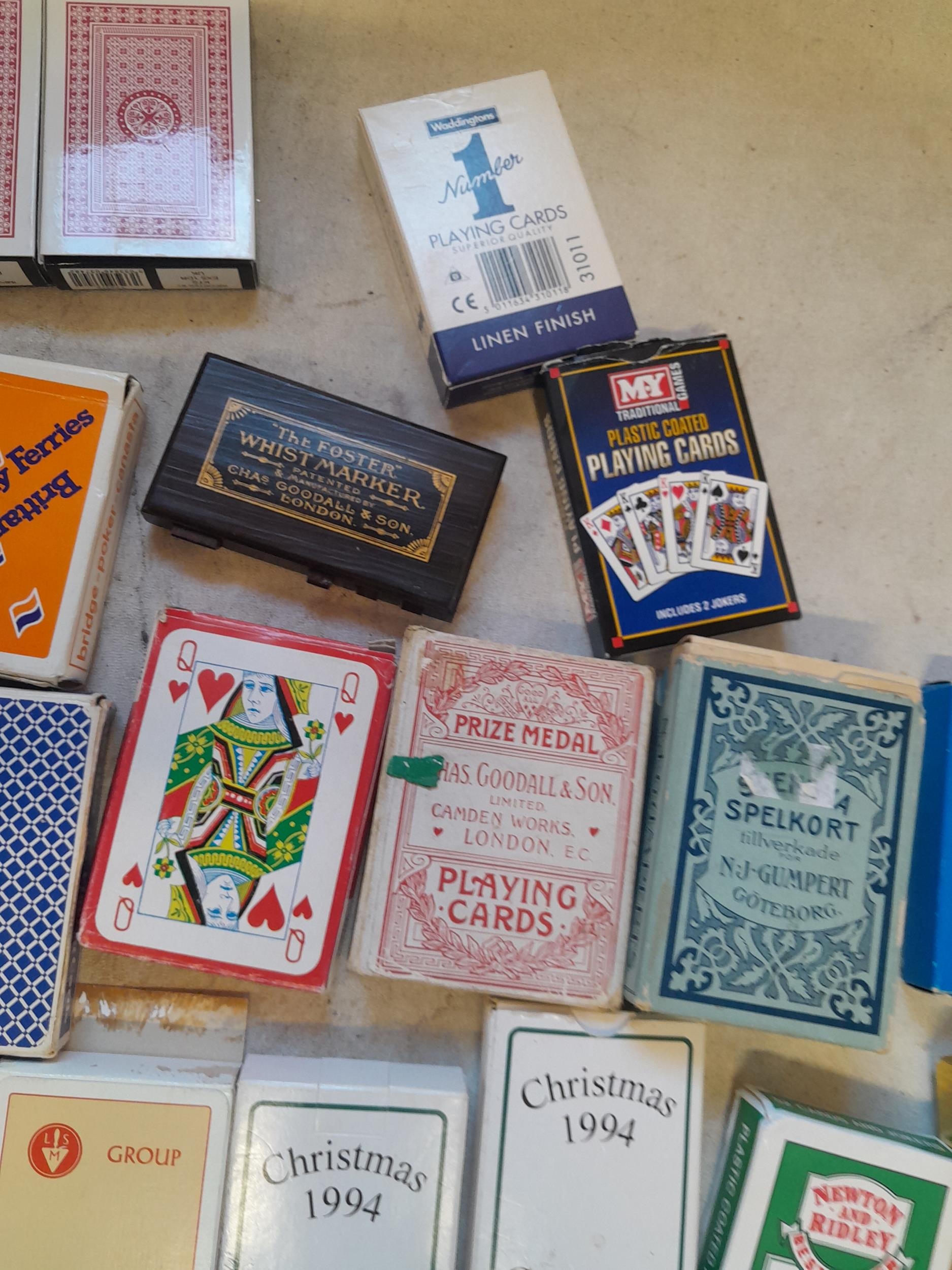 Collection of assorted era playing cards and whist marker, some packs ...