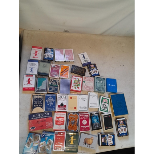 Collection of assorted era playing cards and whist marker, some packs ...