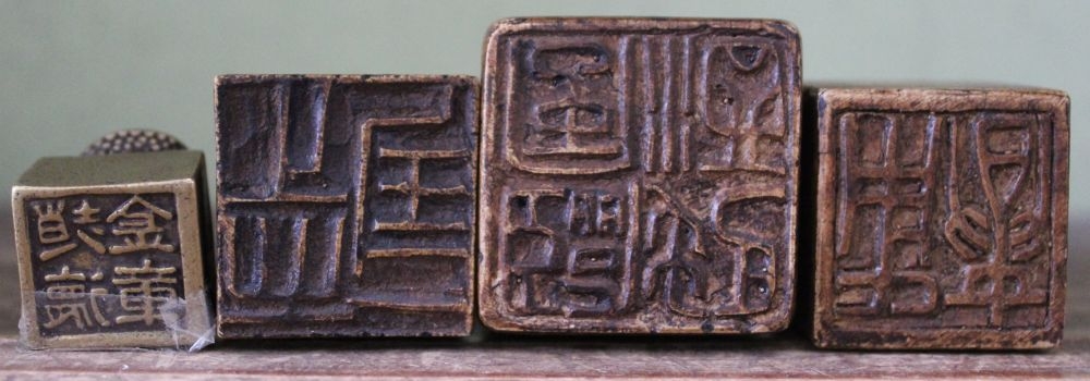 Three old Chinese stone chops/seals with detailed bases and engraved Chinese characters on the surro