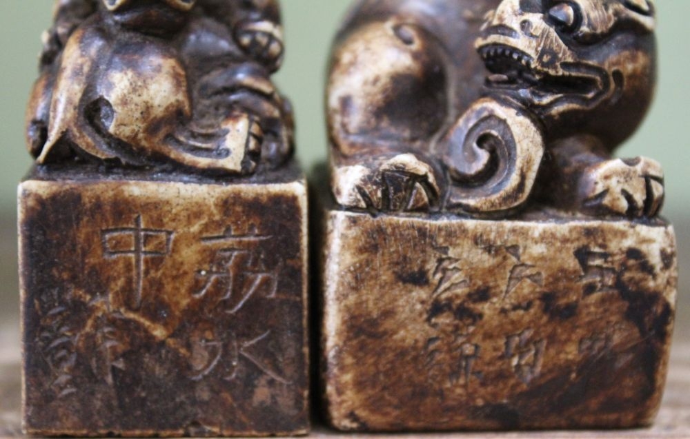 Three old Chinese stone chops/seals with detailed bases and engraved ...