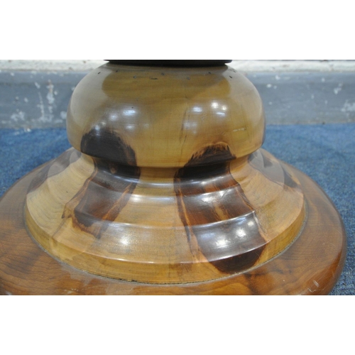 AN AFRICAN HARDWOOD CIRCULAR BUTTERFLY TABLE, the top with lepidoptery ...