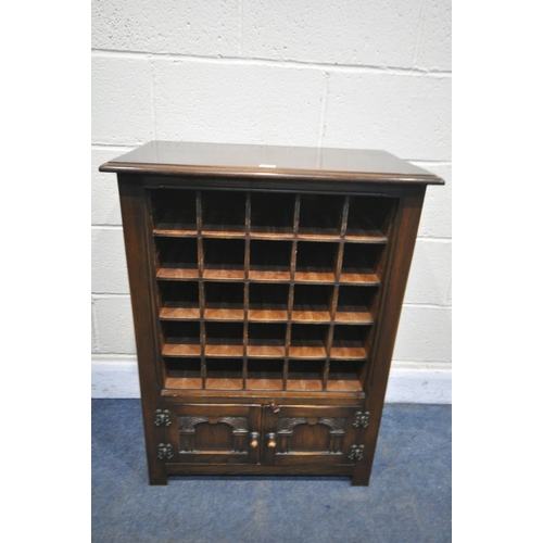A BEVAN FUNNEL REPRODUX OAK 25 HOLE WINE CABINET, with double cupboard ...