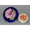 TWO MOORCROFT POTTERY BOWLS, comprising a small footed bowl, decorated ...