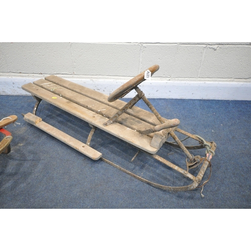 A VINTAGE WOODEN AND METAL SLEDGE, with steering and brakes, along with ...