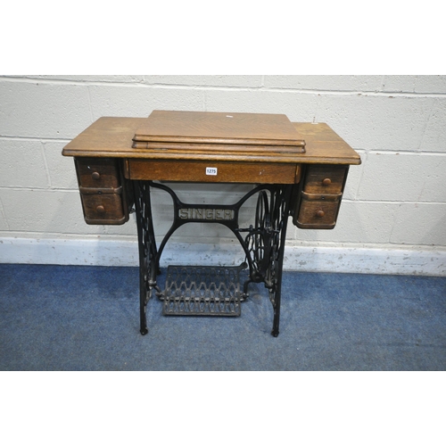AN OAK CASED SINGER TREADLE SEWING MACHINE, with four drawers, serial ...