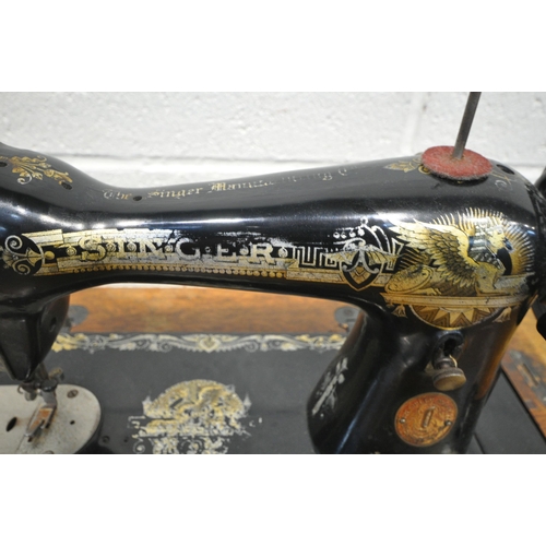 AN OAK CASED SINGER TREADLE SEWING MACHINE, with four drawers, serial ...