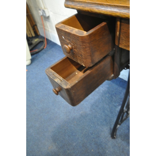 AN OAK CASED SINGER TREADLE SEWING MACHINE, with four drawers, serial ...