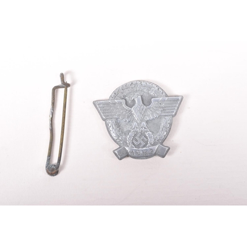 A GERMAN GESTAPO WARRANT DISC WOUND BADGE AND THREE OTHER ITEMS, the Gestapo disc is stamped 9843 on