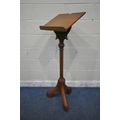 A 20TH CENTURY OAK LECTERN, with shaped supports, raised on a hexagonal ...
