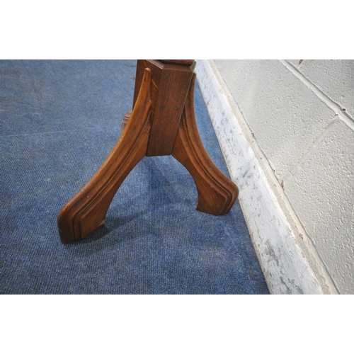 A 20TH CENTURY OAK LECTERN, with shaped supports, raised on a hexagonal ...