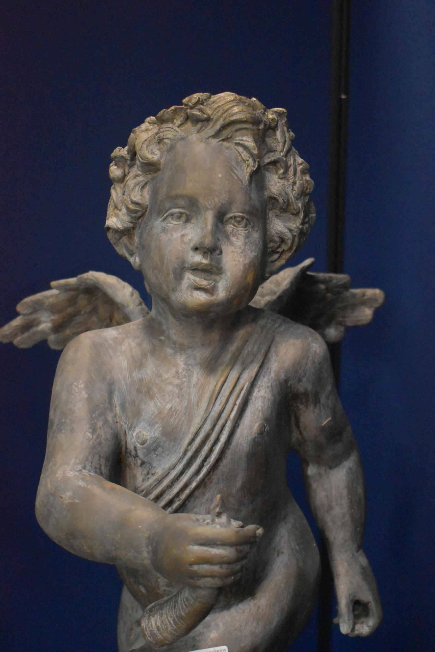 A SECOND HALF 20TH CENTURY WEATHERED BRONZE FIGURE OF CHERUB POSED ...