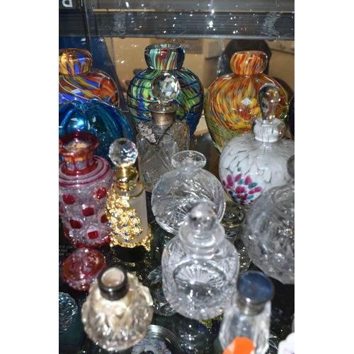 A GROUP OF SCENT BOTTLES, twenty one examples to include a pink and ...