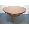 A REGENCY STYLE OAK CIRCULAR BREAKFAST TABLE, raised on a turned ...
