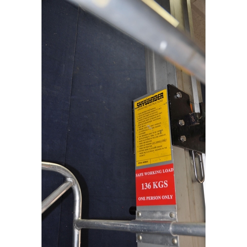 A SKYWINDER VERTICAL ACCESS PLATFORM with hand winch to elevate, fold ...