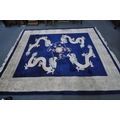 G H FRITH LIMTED, A LARGE BLUE GROUND ORIENTAL WOOLEN RUG, depicting ...