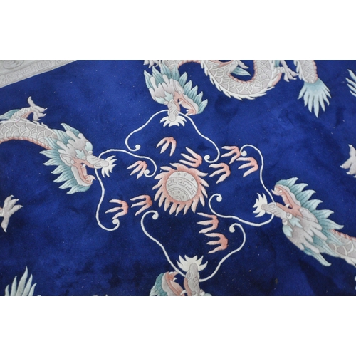 G H FRITH LIMTED, A LARGE BLUE GROUND ORIENTAL WOOLEN RUG, depicting ...