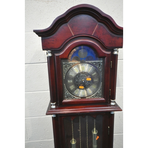 A REPRODUCTION MAHOGANY LONGCASE CLOCK, the arched door enclosing an 11 ...