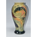 A BOXED MOORCROFT POTTERY 'CARP' PATTERN VASE, of baluster form, tube ...