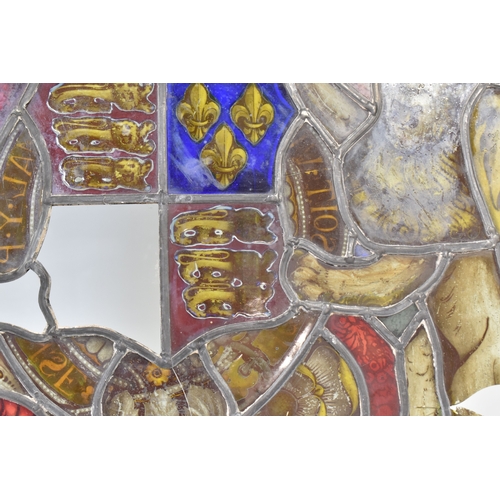 A STAINED GLASS ROYAL CREST mounted in leaded frames depicting the ...