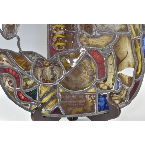 A STAINED GLASS ROYAL CREST mounted in leaded frames depicting the ...