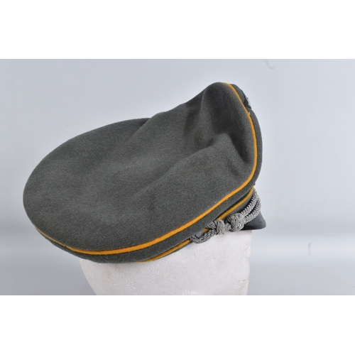 A GERMAN CAVALRY HEER PEAKED CAP, this has a bullion cockade and a ...