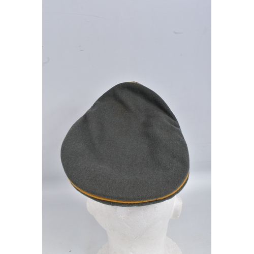 A GERMAN CAVALRY HEER PEAKED CAP, this has a bullion cockade and a ...