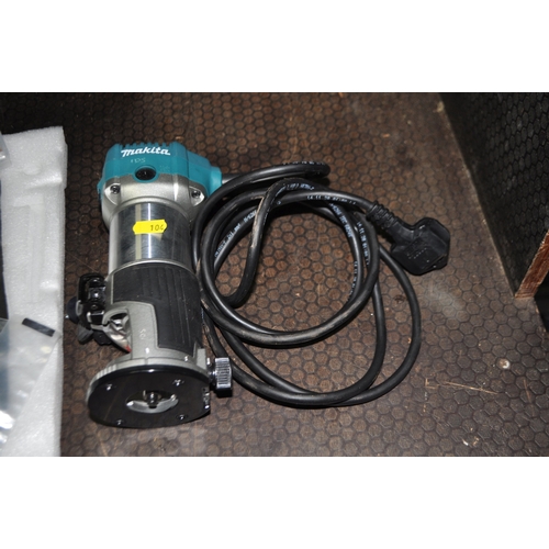A MAKITA RT0700C 240V TRIM ROUTER with a Neu auxiliary circle guide ...
