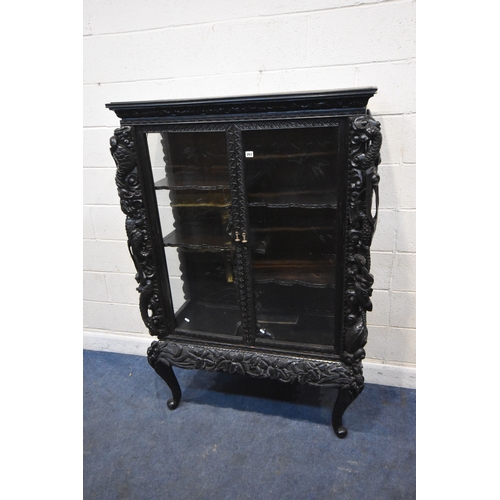 AN EARLY 20TH CENTURY JAPANESE EBONISED OAK DISPLAY CABINET, with ...