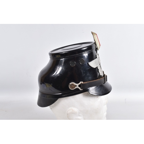 A GERMAN MUNICIPLE POLICE SHAKO HELMET WITH A LARGE EAGLE ON THE FRONT ...