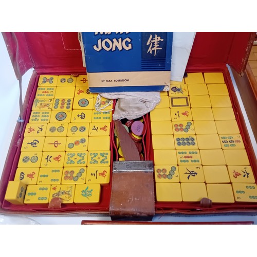 Two Chinese Mahjong sets, chess pieces within a box and loose dices