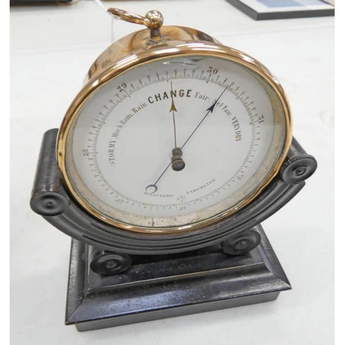 BRASS CASED HOLOSTERIC BAROMETER BY HPBN ON A CARVED STAND