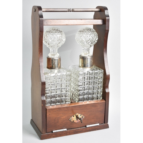 A Modern Mahogany Two Bottle Tantalus, with Key, 36cms High