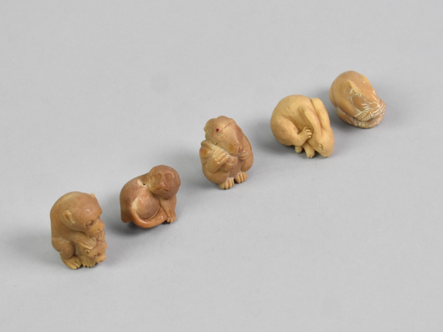 A Collection of Five Cast Resin Faux Nut Animals