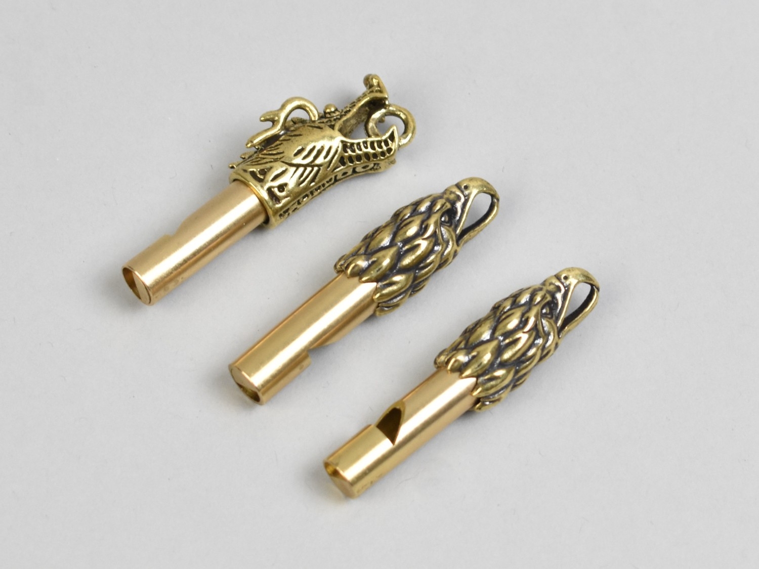 A Collection of Three Gilt Brass Whistles, Two in the Form of Eagles ...
