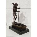 A bronze figure of a goblin punting a boat on a marble base, height 14 ...