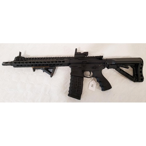 A Combat Machine air soft machine gun with dot sight and a scope. No ...