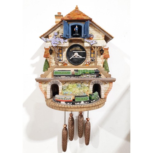 A resin Flying Scotsman electric wall clock with moving train and ...