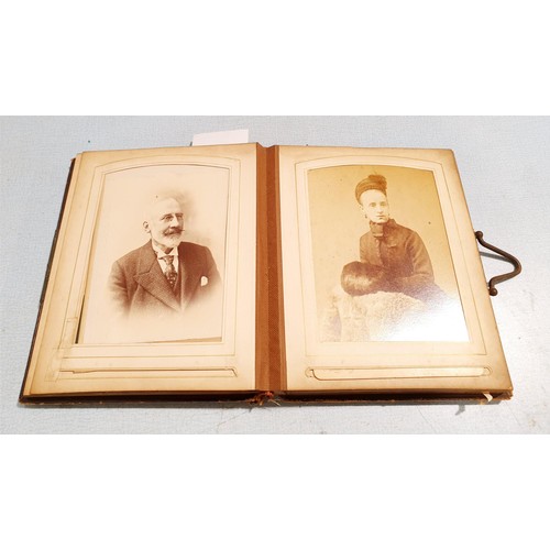 An album containing antique photographs together with three ferrotype ...