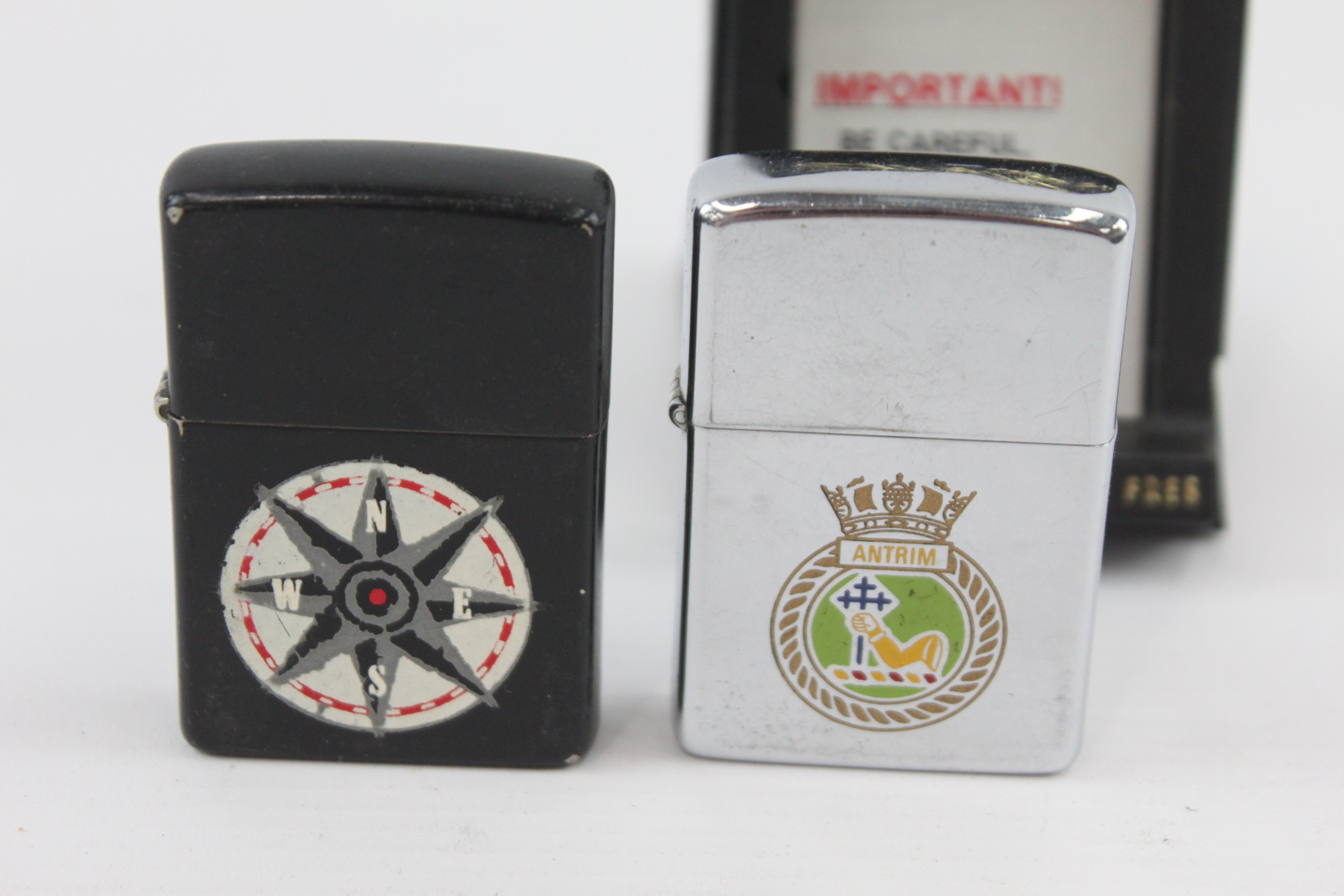 2 x Assorted ZIPPO Cigarette Lighters Inc HMS Antrim Crest, Compass ...