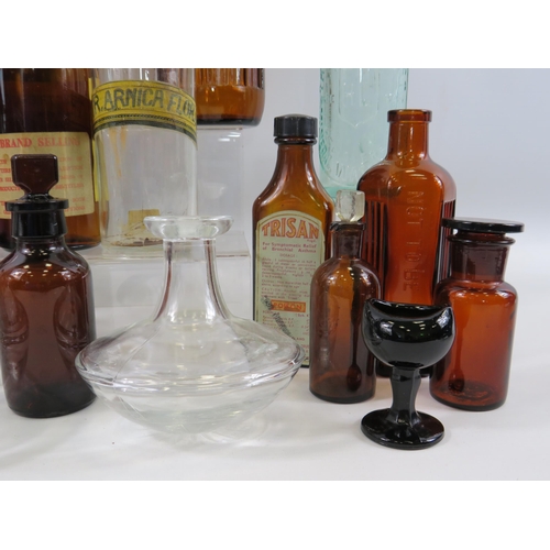 Large selection of various coloured vintage medical bottles.