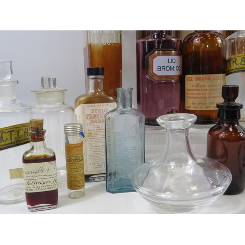 Large selection of various coloured vintage medical bottles.