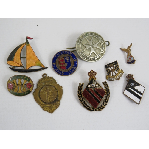 Selection of various vintage enamel badges.