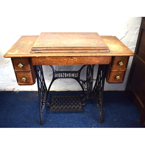 Singer sewing machine treadle table with four drawer cabinet. See photos.