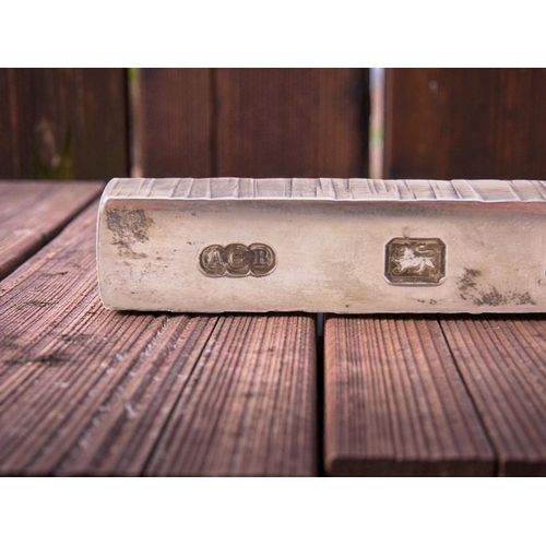 A silver ingot bar hallmarked 1990. Weight 245g
