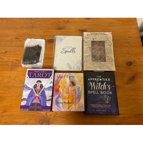 Collection of tarot card sets and spell books including some crystals