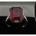 A yellow and white metal ring with red stone, marked .333. Size N ...
