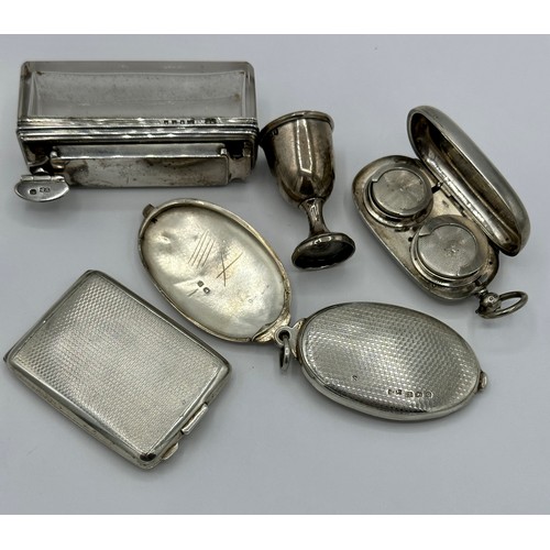 An assortment of silver items to include a screw down travelling ...