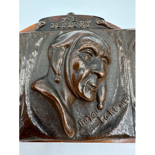 An Arts and Crafts copper relief moulded plaque, 'Y'e Jesters ...