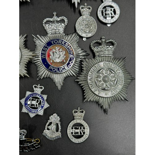 An assortment of Police helmet, cap badges and buttons. Large Police ...