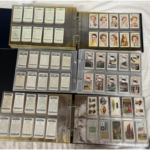 Seven albums containing 61 full sets of cigarette cards to include ...